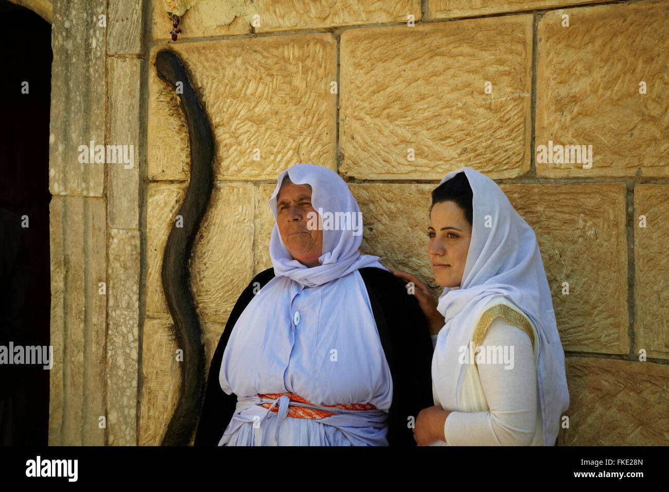 Two yezidi women inside the holy temple of Lalesh. Iraqi Kurdistan ...
