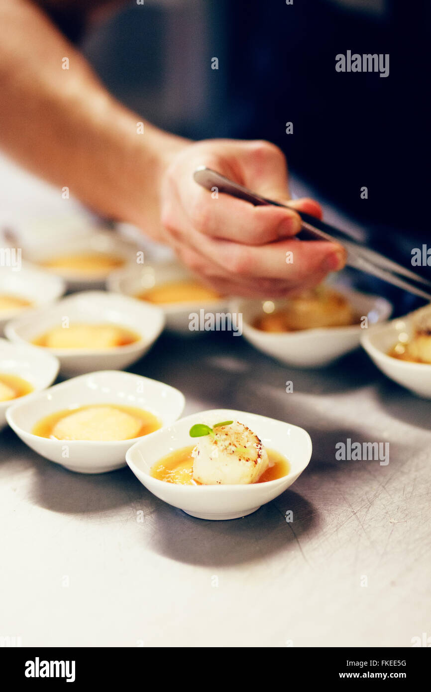 Chef plating scallop dish Stock Photo - Alamy
