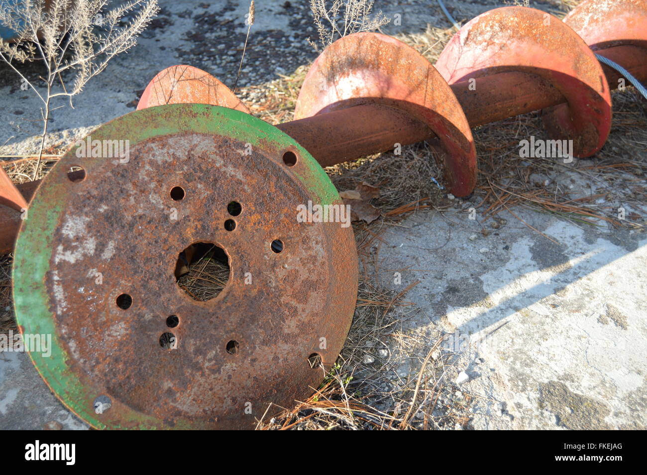 A picture of a rustic auger and a old disk taken at even Stock Photo ...