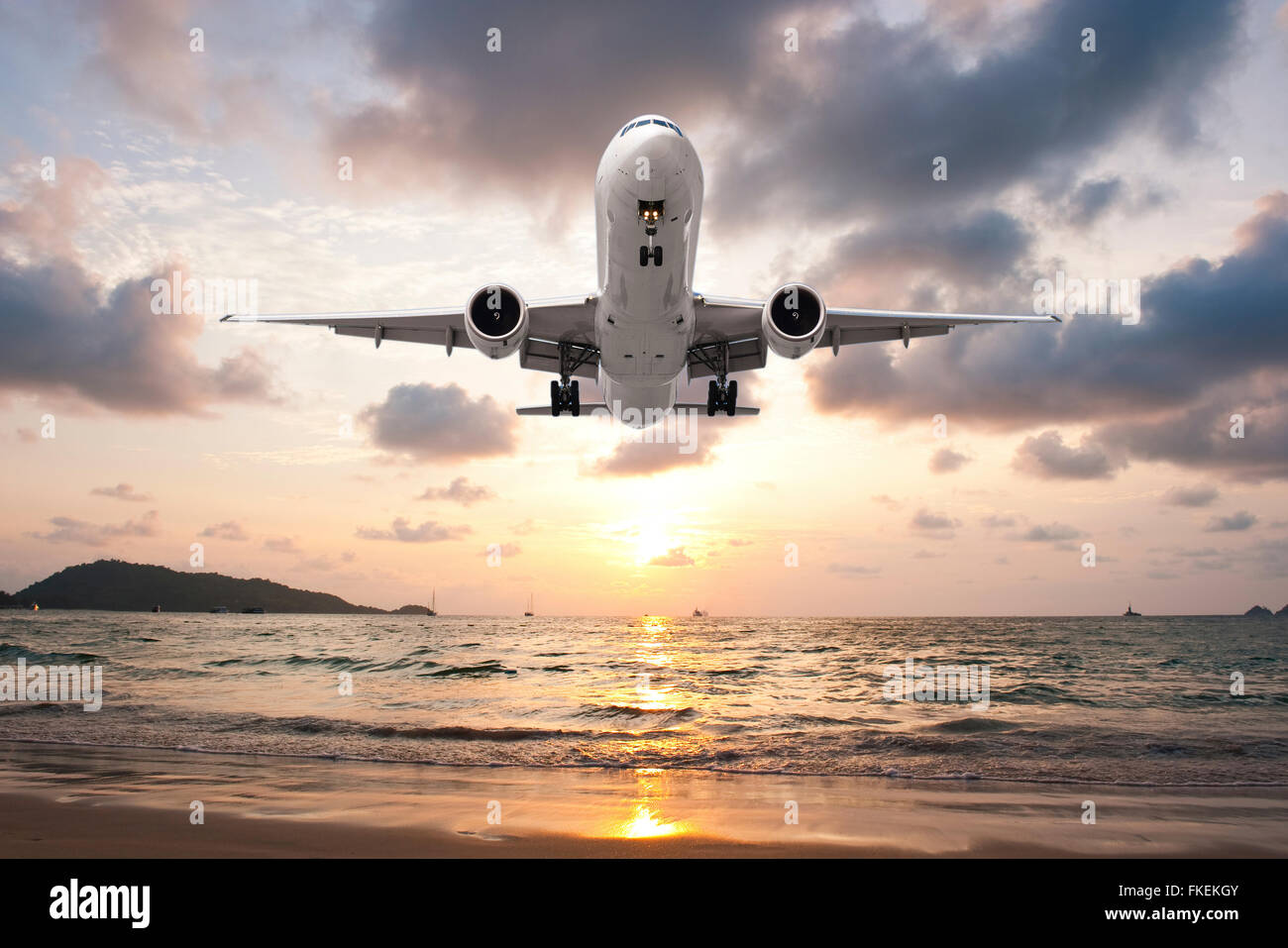 Airplane Landing in sunset Stock Photo - Alamy