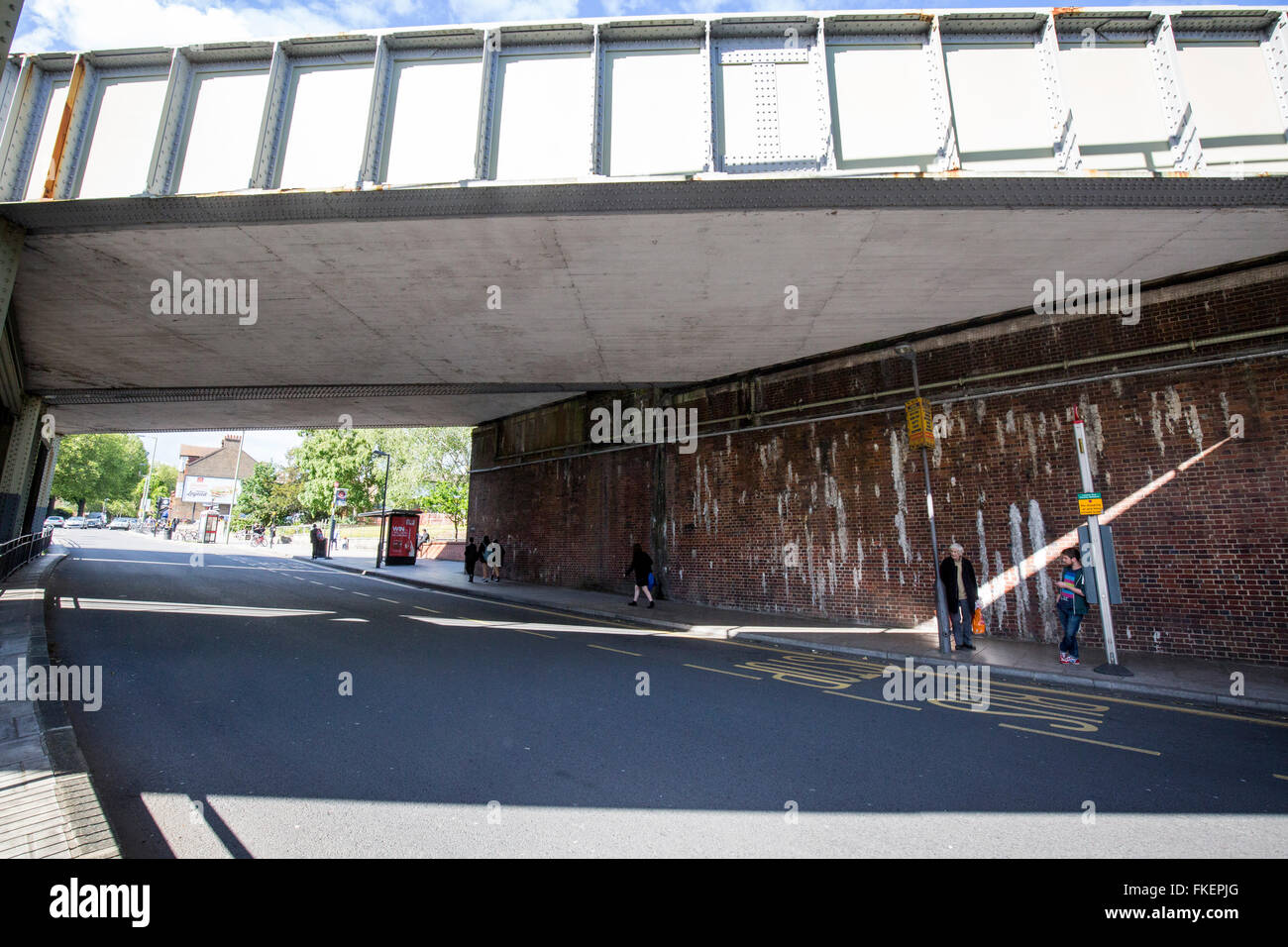 Shaft of light across bus stop under tube bridge Stock Photo - Alamy
