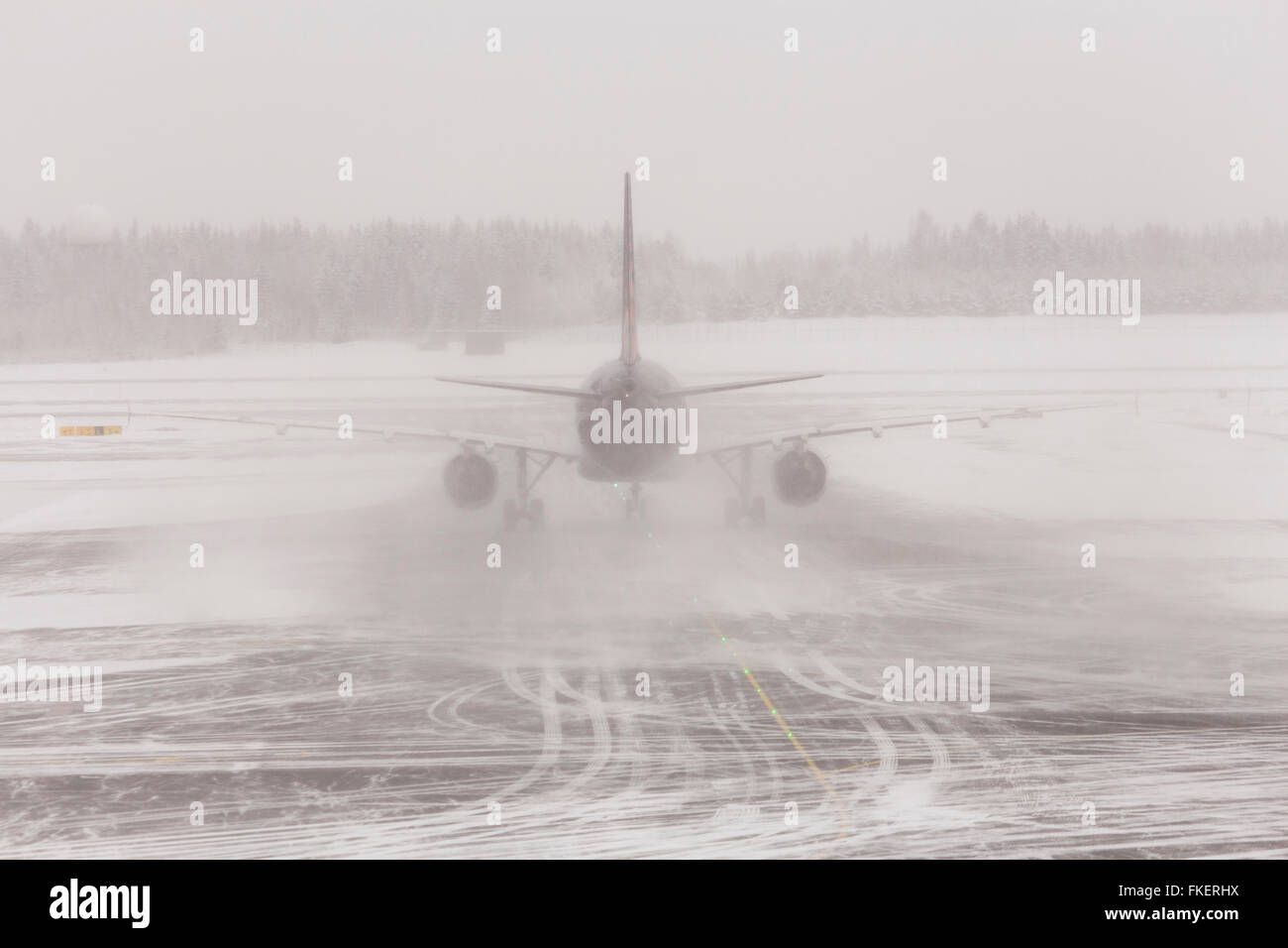 Airplane in bad weather, snow storm on snowy runway, Gardermoen airport ...