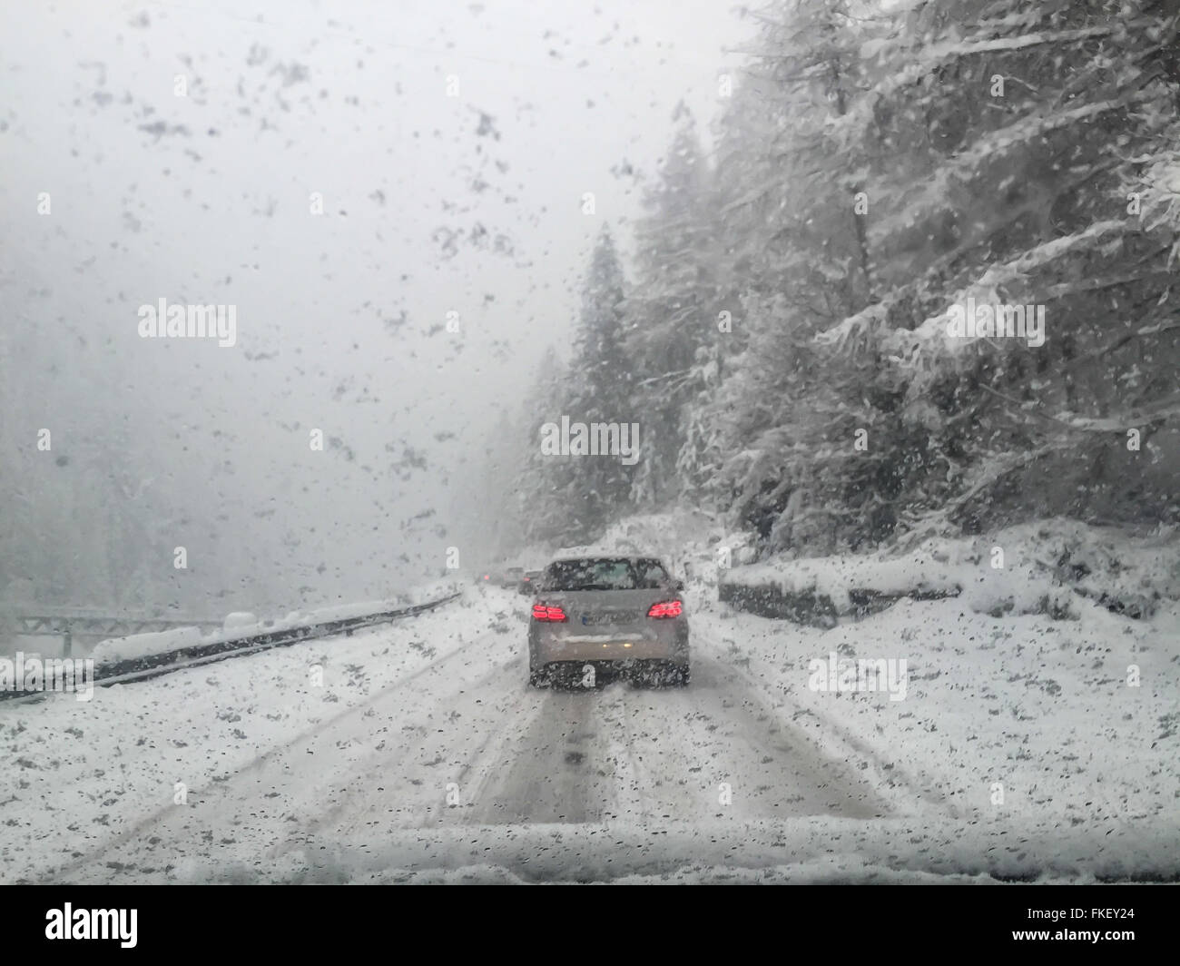 Driving in winter through the mountains. Alpine roads covered with snow ...