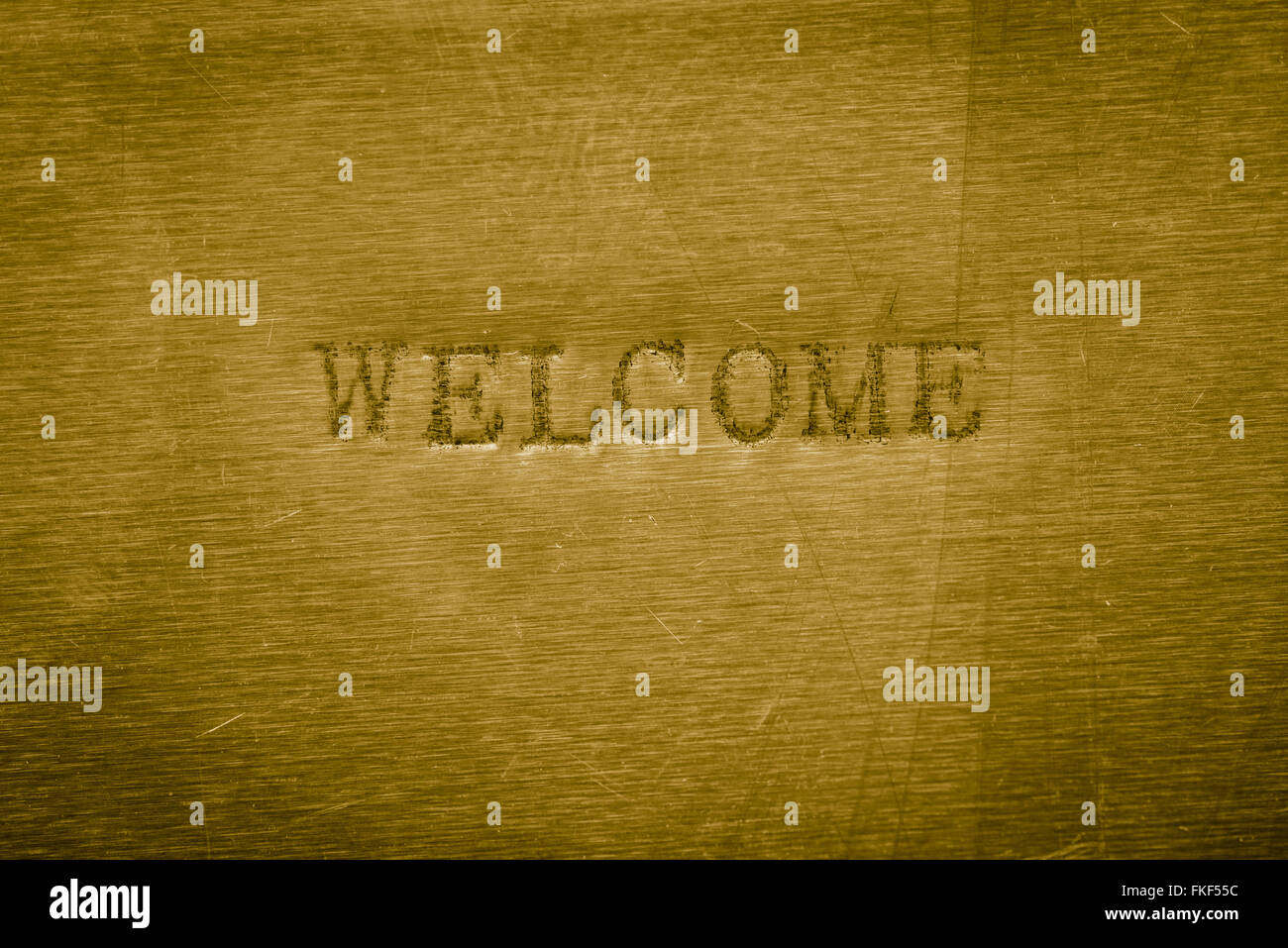 word welcome printed on golden metallic background texture Stock Photo ...