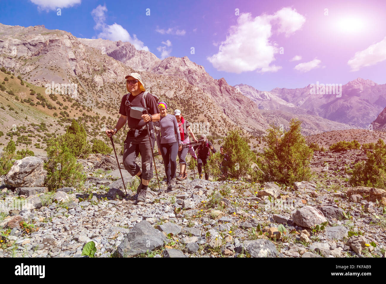 Group of Hikers Walking into Wilderness Stock Photo - Alamy