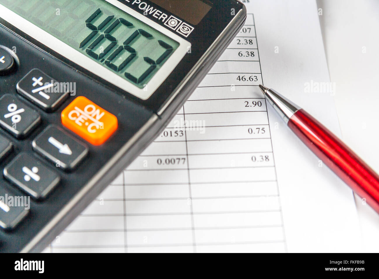 A Pen And a Calculator Sit On a Page With Numbers Stock Photo - Alamy