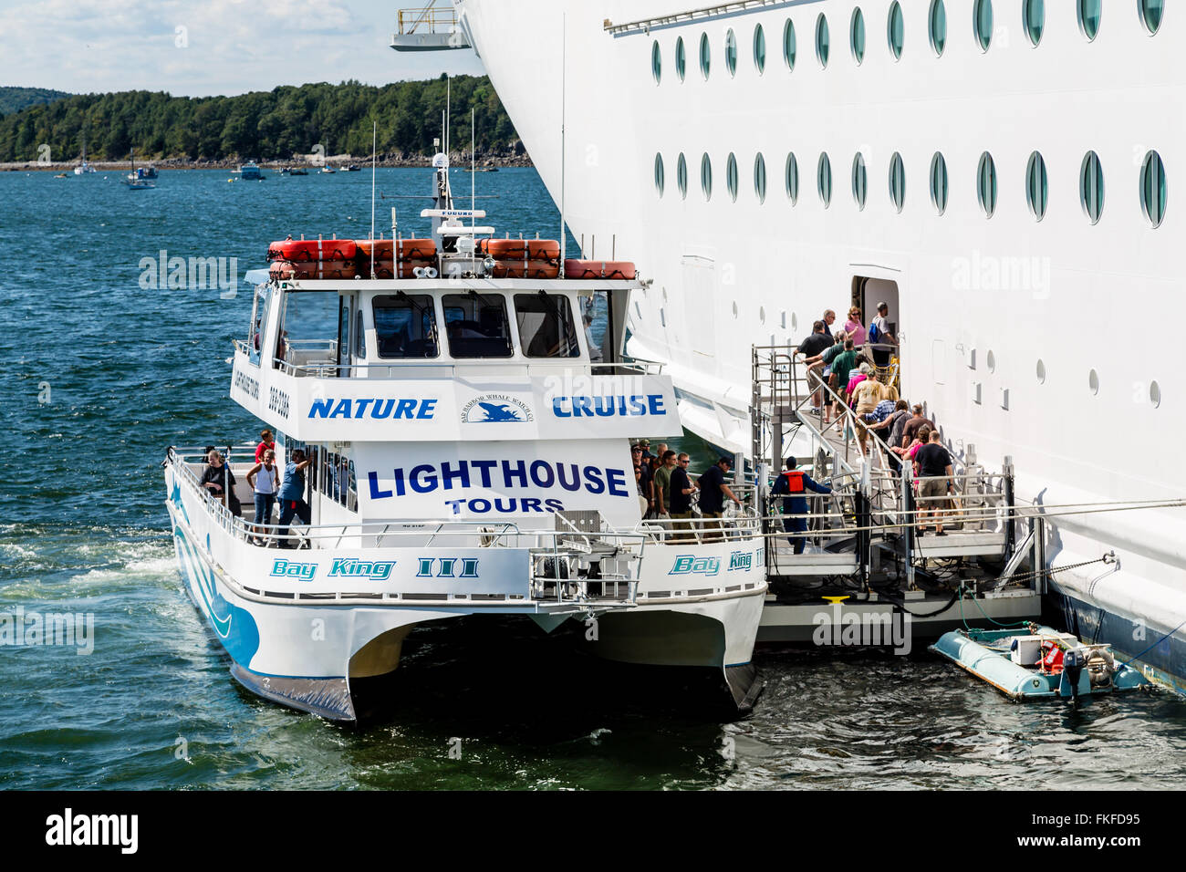 Tour Boat Unloading passengers at Cruise Ship Stock Photo - Alamy