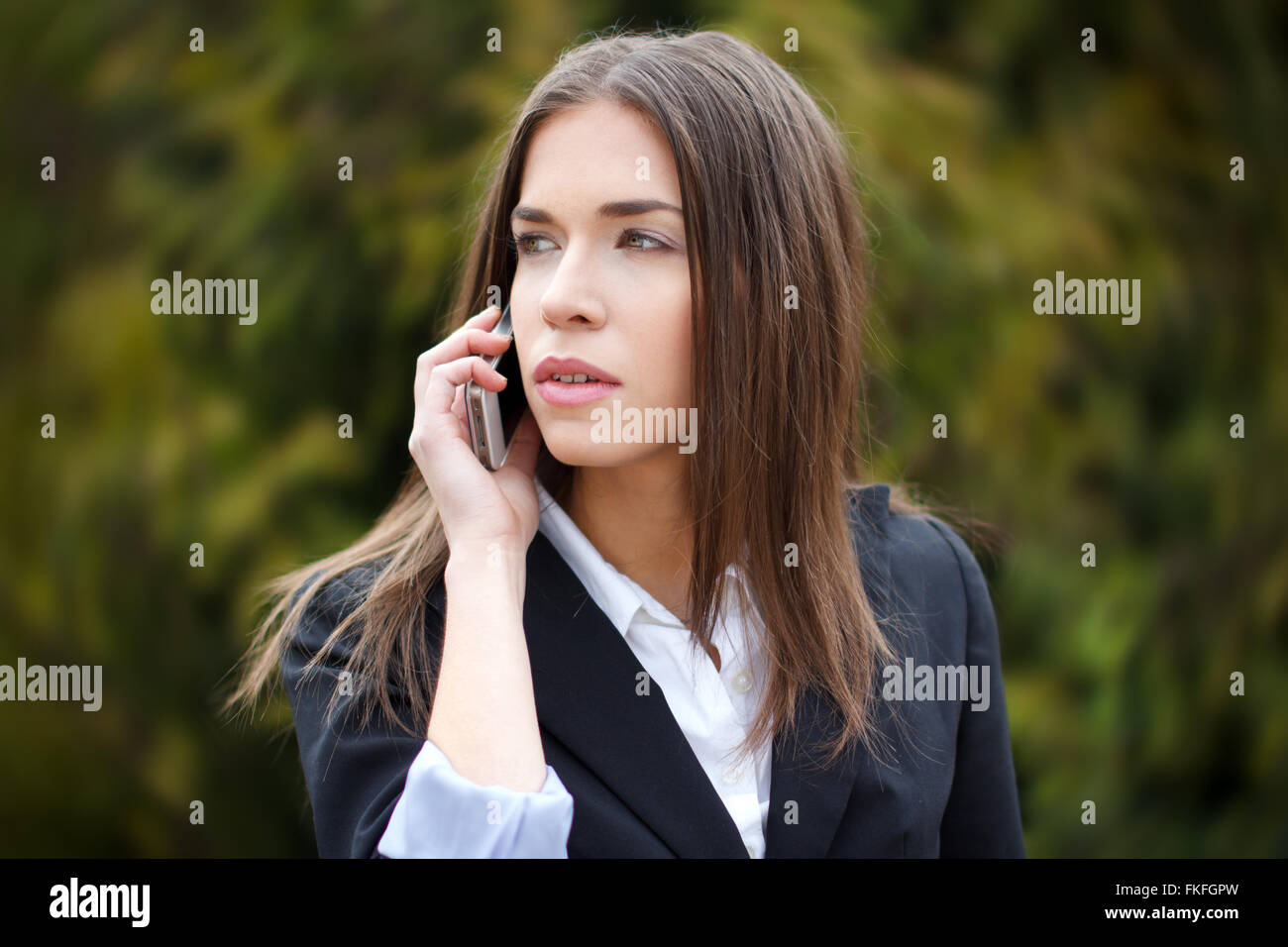 Attractive businesswoman with smartphone calling at outdoor Stock Photo ...