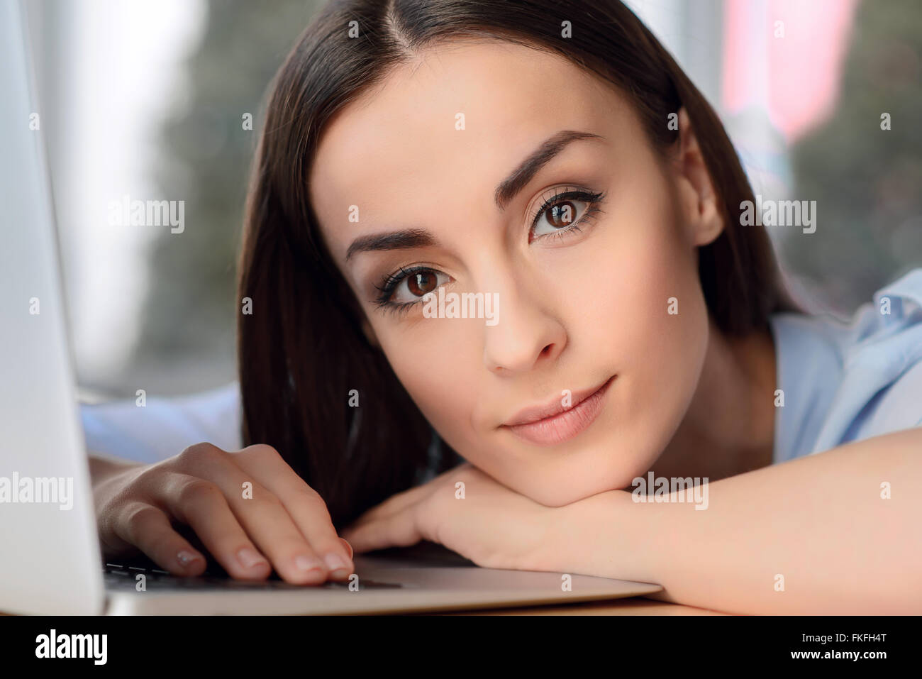 Pleasant woman leaning head on her arms Stock Photo - Alamy