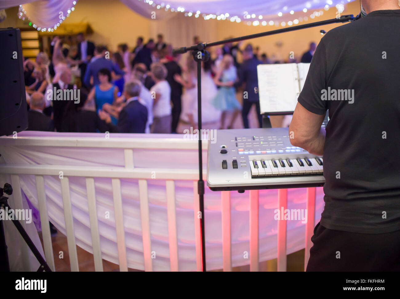 Musician playing on musical keyboard Stock Photo - Alamy