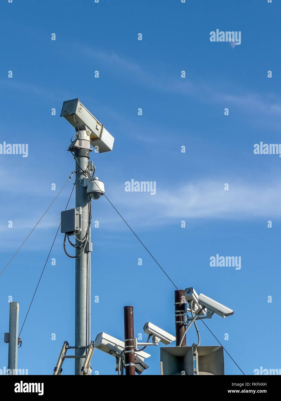 Multiple surveillance cameras with blue sky and moon Stock Photo - Alamy