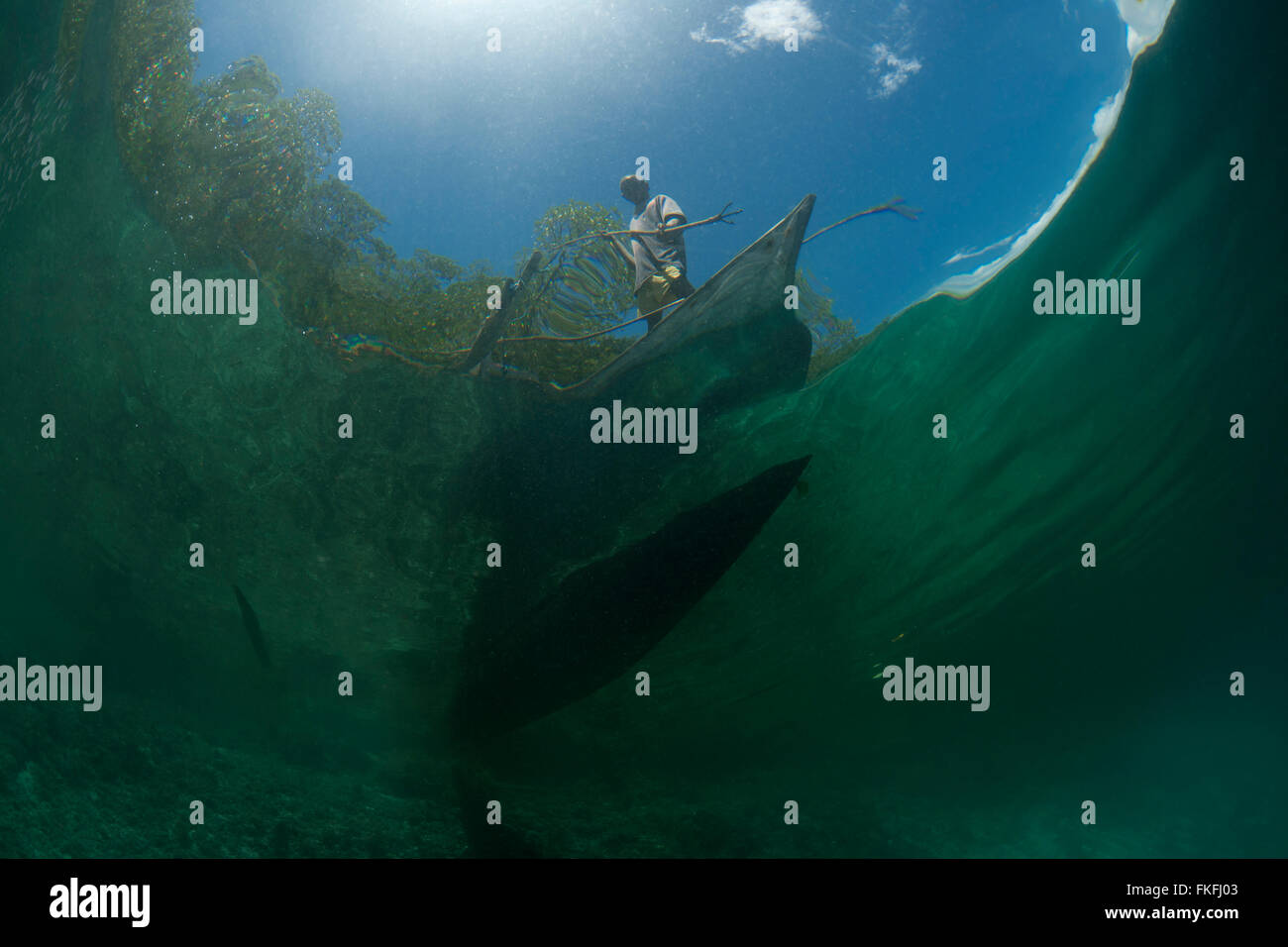 Reflection of an outrigger dugout canoe from underwater. This is what ...