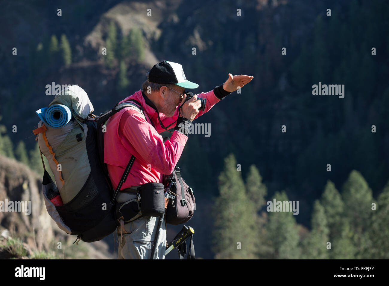 Photographer using his hand to shade his camera's lens, Wenaha River ...
