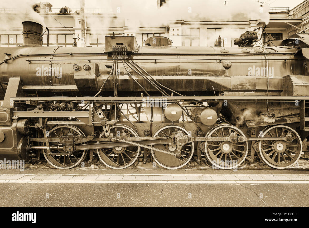 Retro steam train stands on the station before departure at spring ...