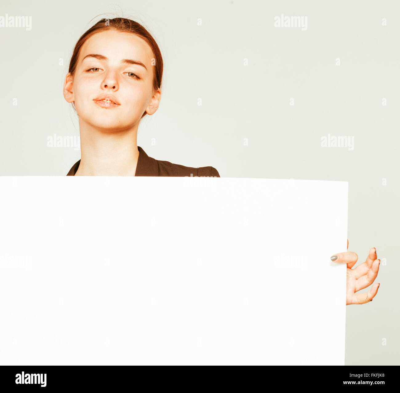 young pretty brunette girl with placard on white background wearing ...