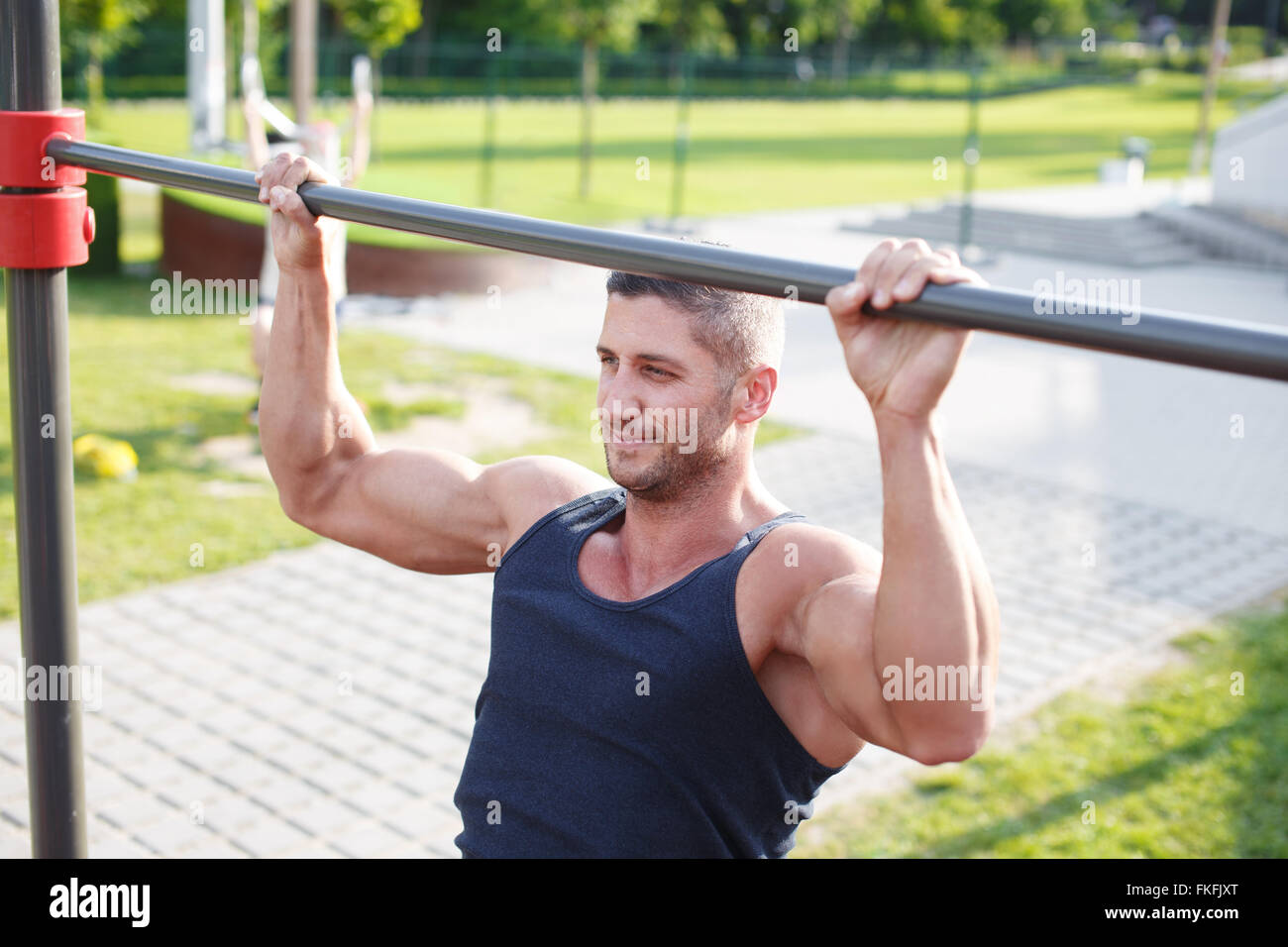 Sporty man pull-up outdoor in park on horizontal bar Stock Photo - Alamy