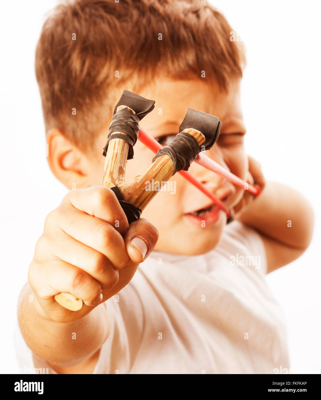 little cute angry real boy with slingshot isolated Stock Photo - Alamy