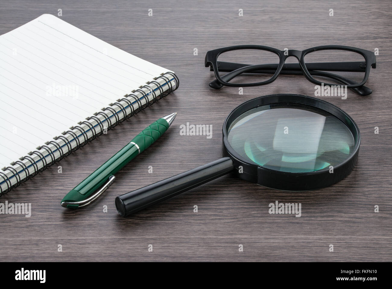 Blank notebook with Magnifier on the deskr, close up, accountant Stock ...