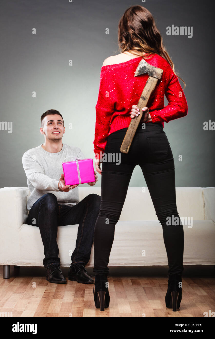 False feelings, relations problem. Trusting guy giving present pink box ...