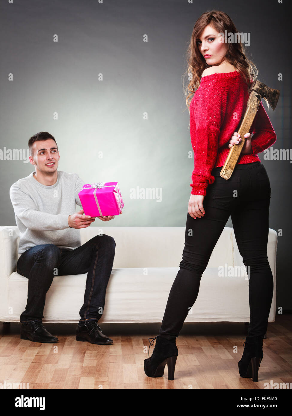 False feelings, relations problem. Trusting guy giving present pink box ...