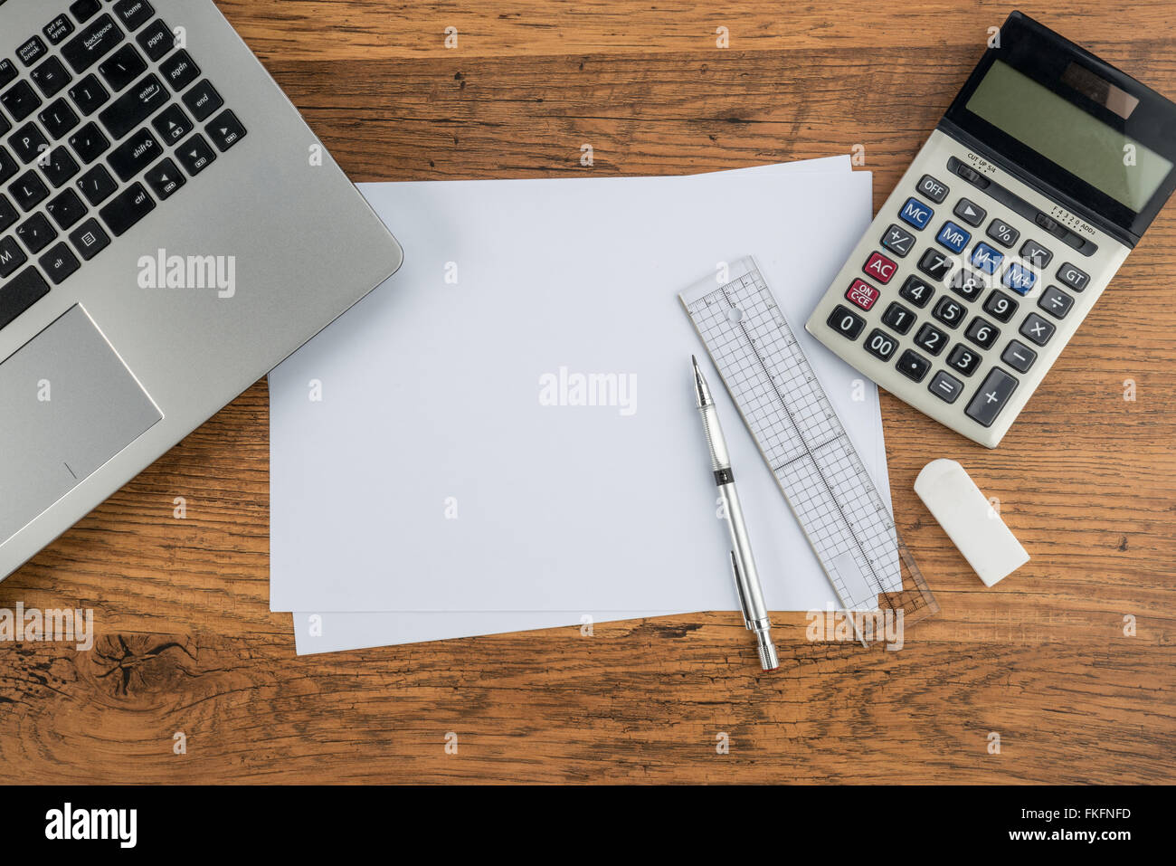 Laptop, paper pen Ruler Calculator and Eraser on work desk Finance ...