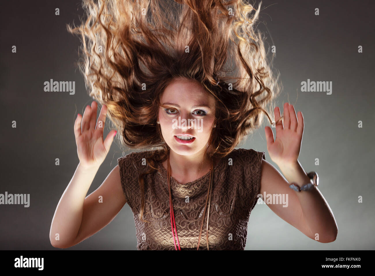 Portrait of mysterious enigmatic woman in studio on grey. Young ...