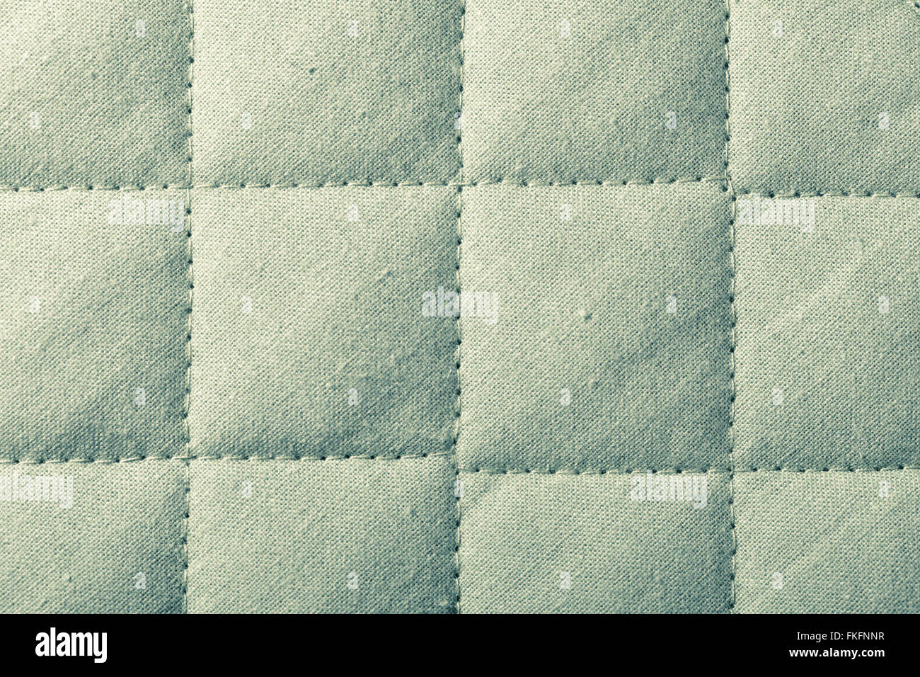 Abstract green soft textured background with squares. Quilted textile ...