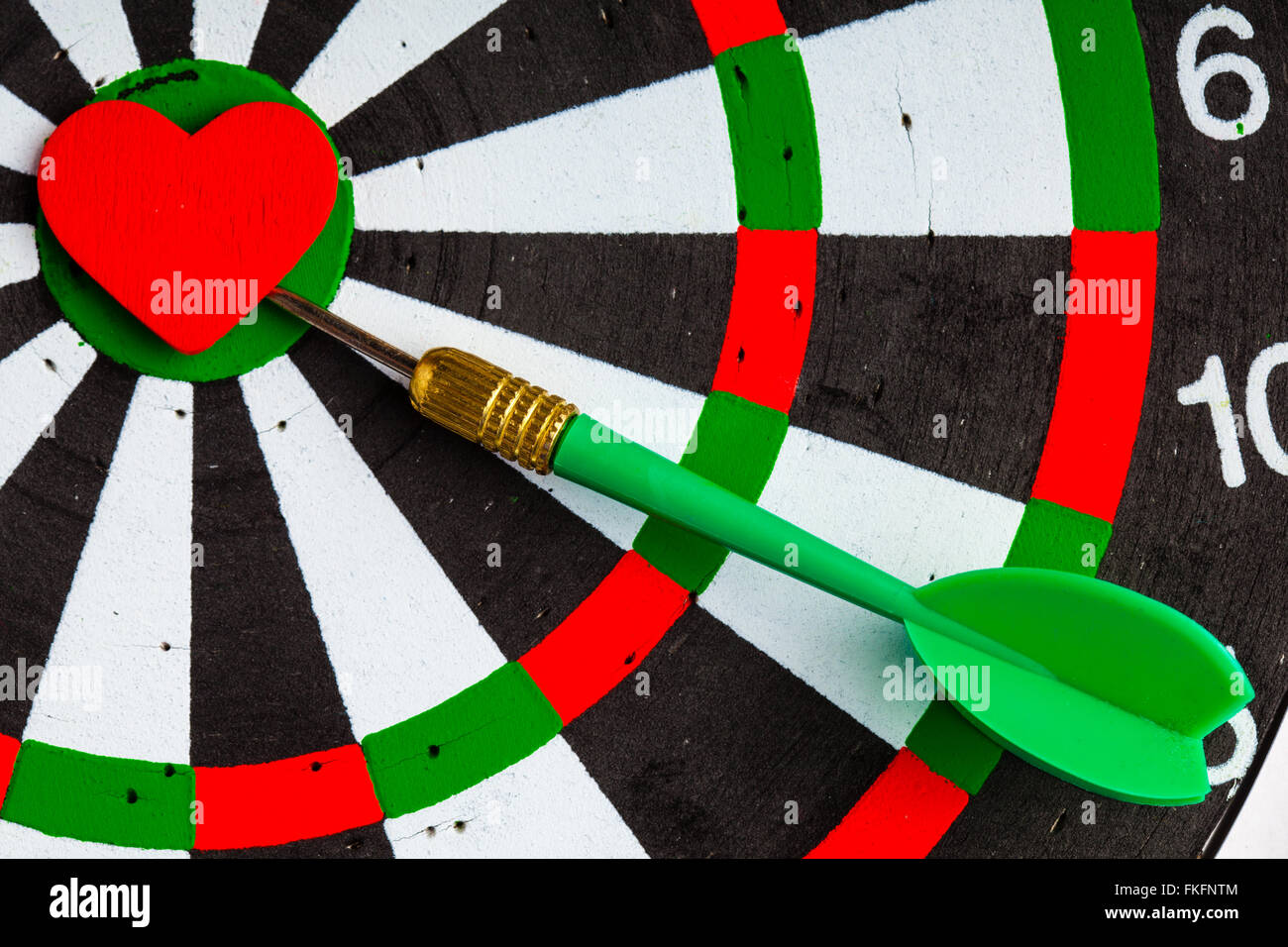 Closeup of black and white target with dart in red valentine heart love ...