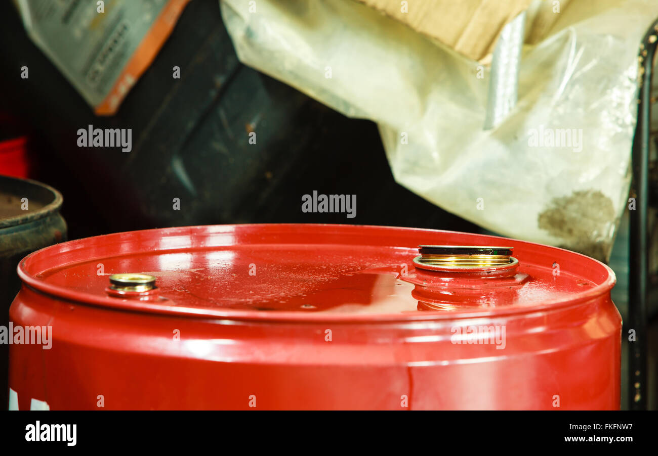 Car servicing oil change. Red oil barrel canister in mechanic garage ...