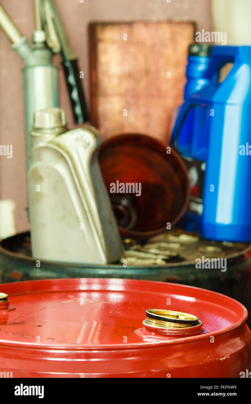 Car servicing oil change. Red oil barrel canister in mechanic garage ...