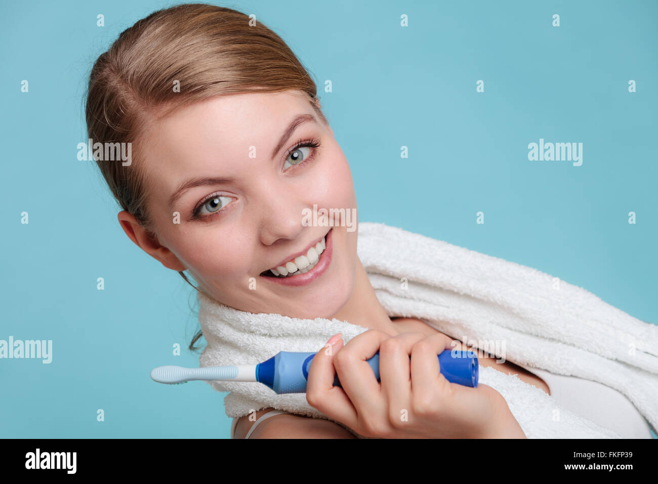 Pretty young girl with brush cleaning white using toothpaste. Happy ...