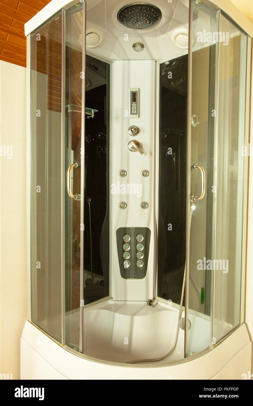 Bathroom interior. Modern big shower cabin with hydro jets in corner ...