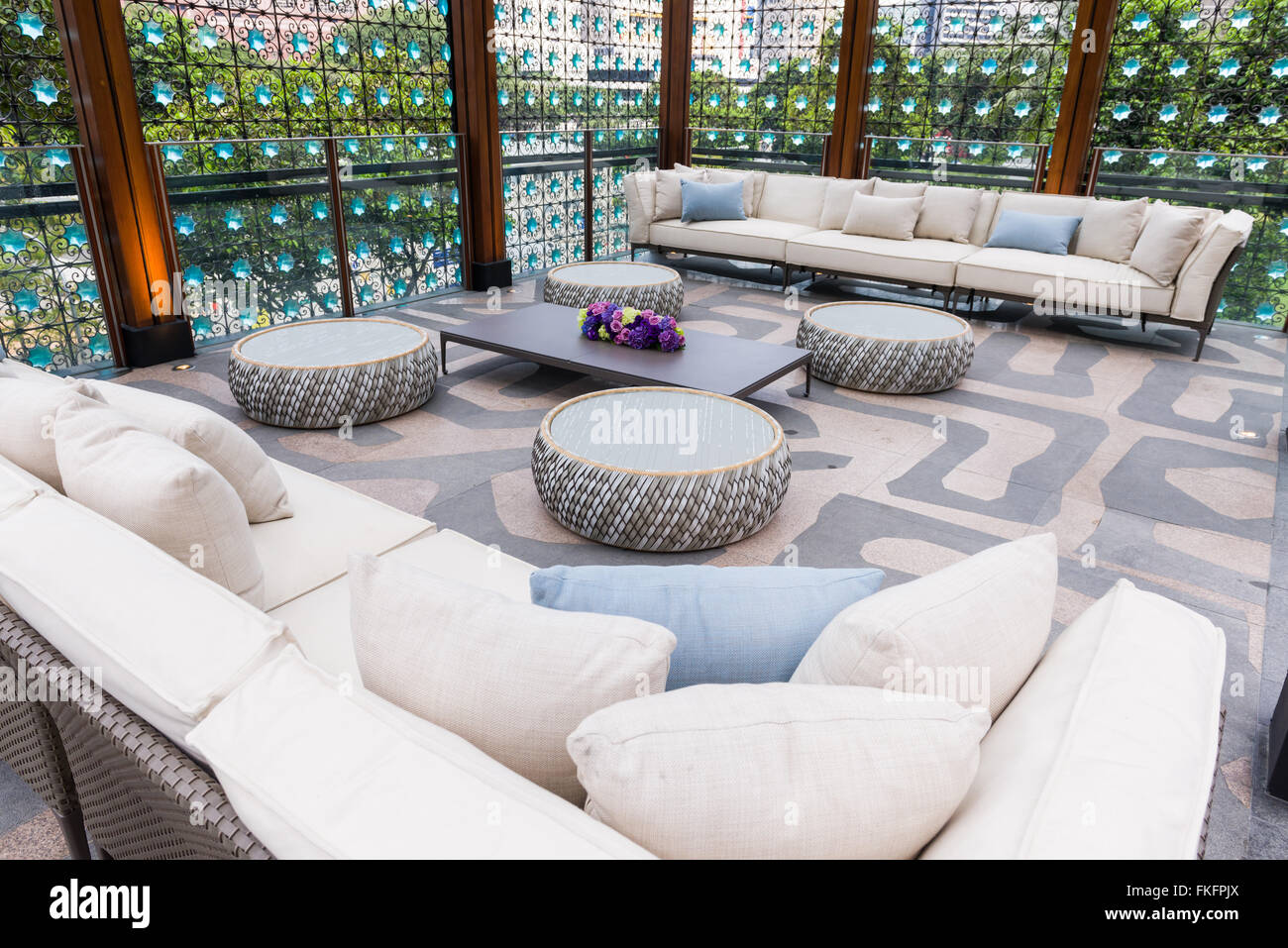 Semi-outdoor relaxation area with comfortable seating and tables Stock ...