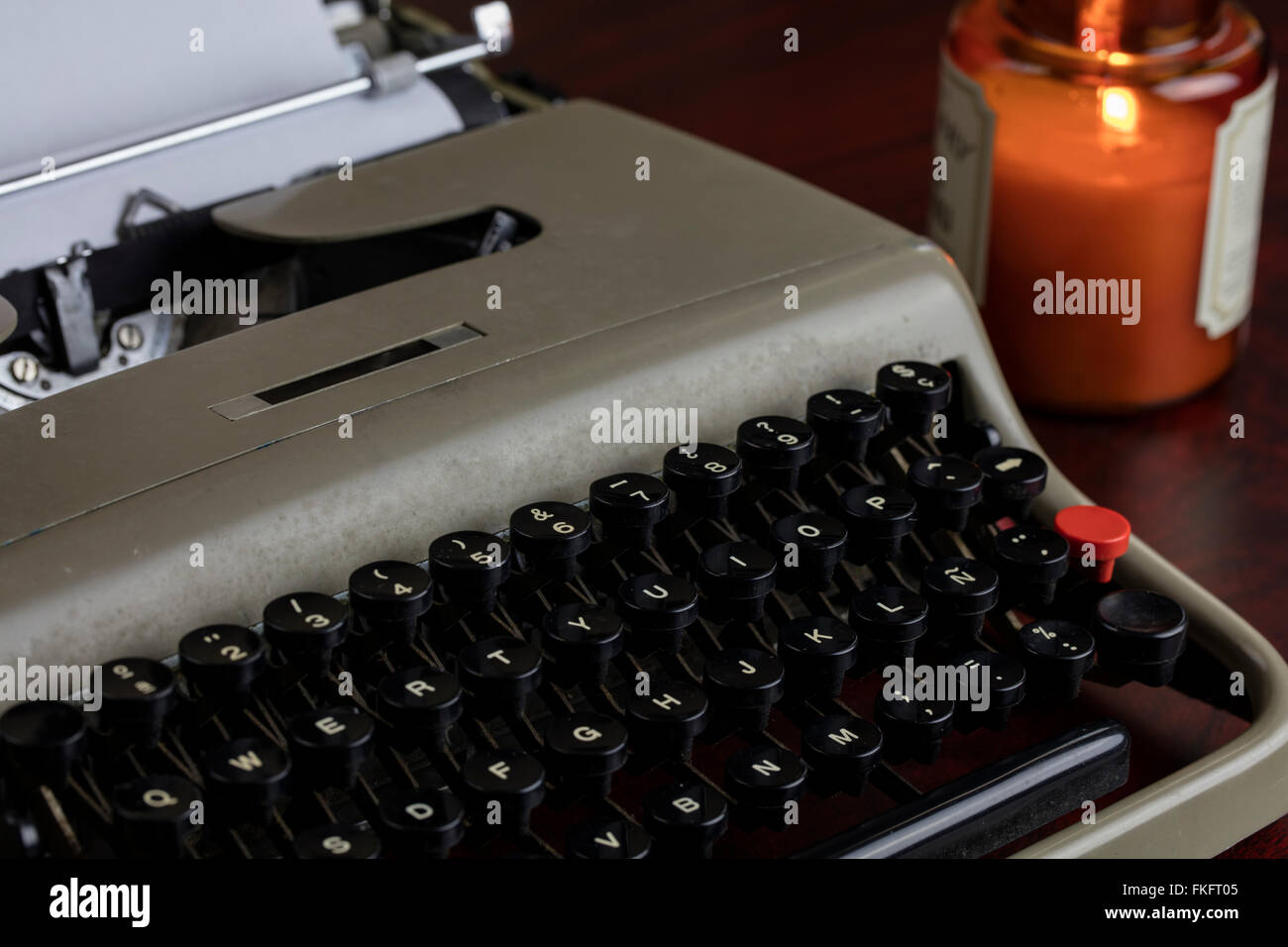 Vintage typewriter and paper on a table under candlelight ready for the ...