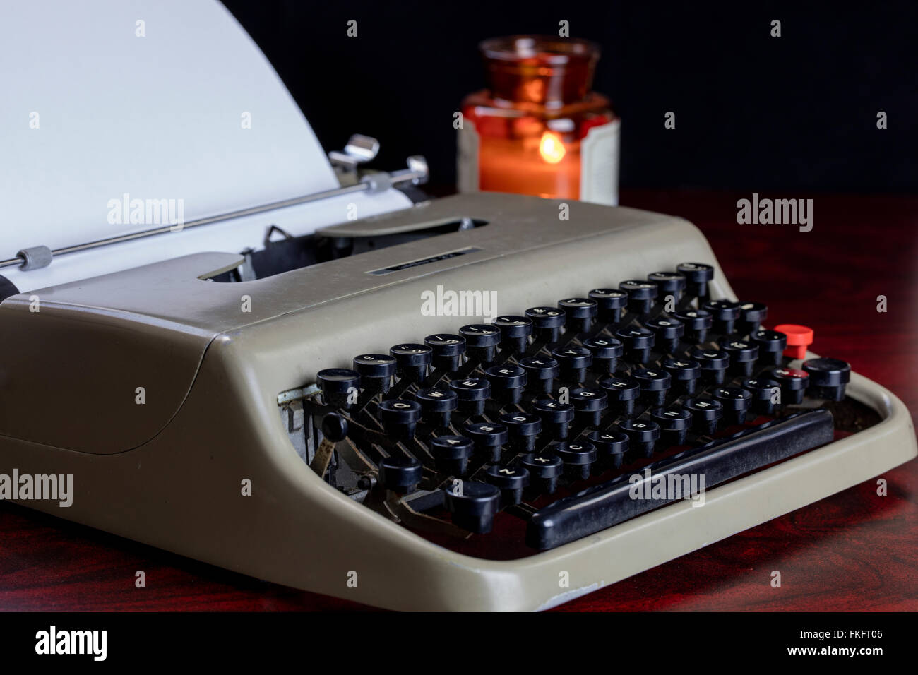 Vintage typewriter and paper on a table under candlelight ready for the ...