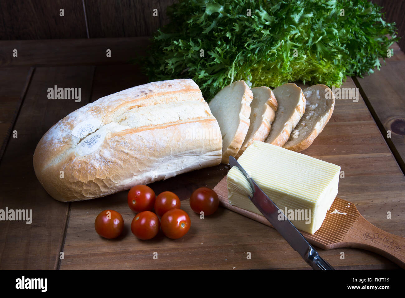 A partially sliced fresh organic White Bloomer/loaf of bread on a ...
