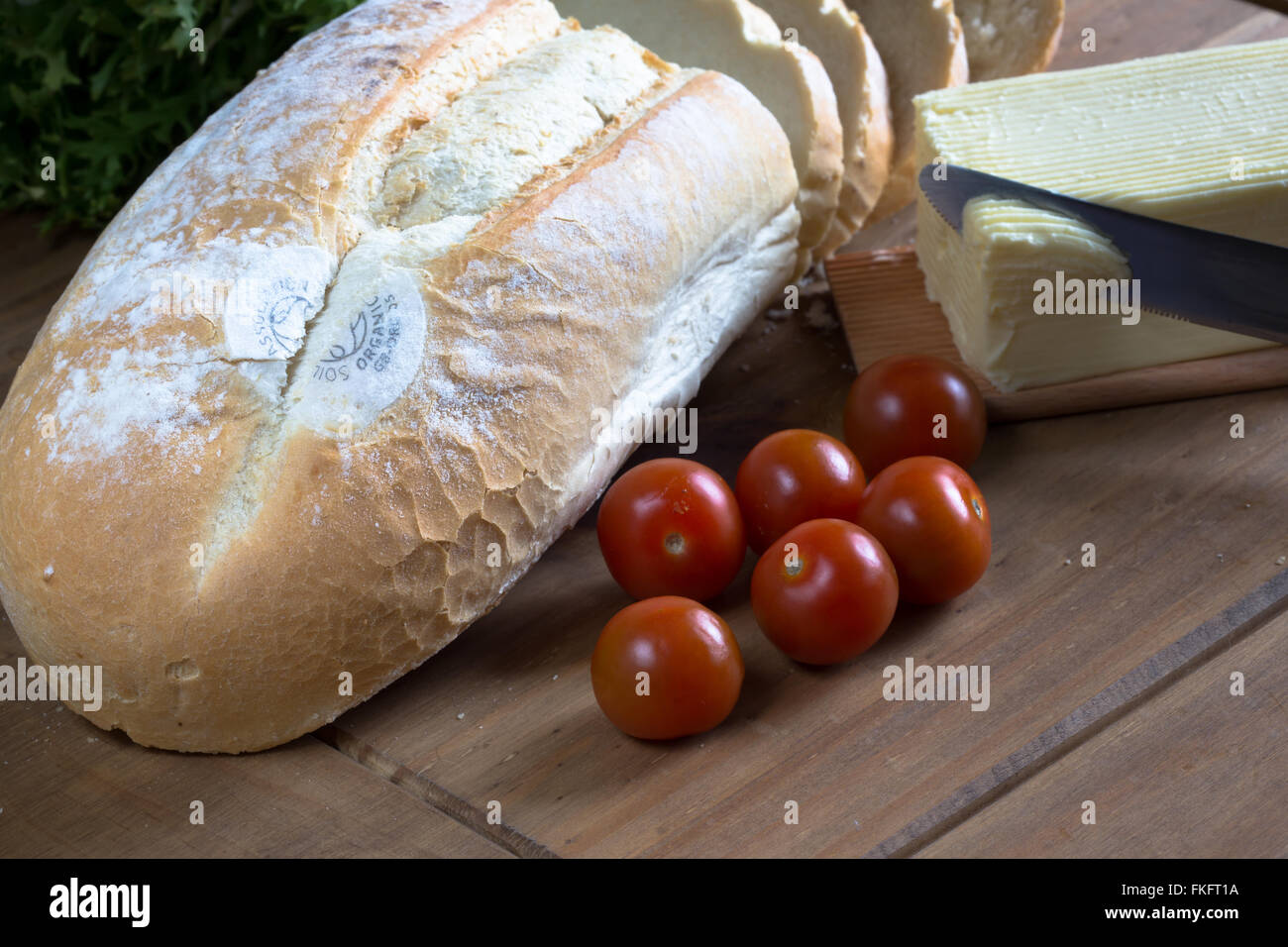 A partially sliced fresh organic White Bloomer/loaf of bread on a ...