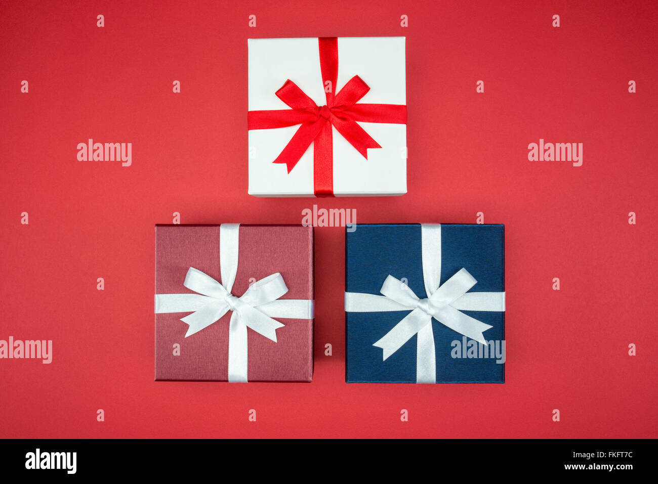 luxury color gift box for holiday event with beautiful silk wrap on red ...