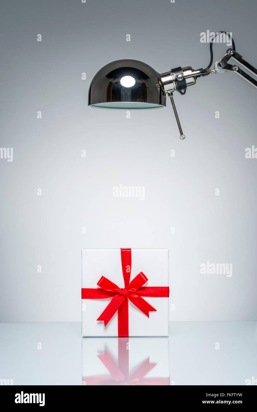 lighting up gift box present with desk lamp on round studio lighting ...