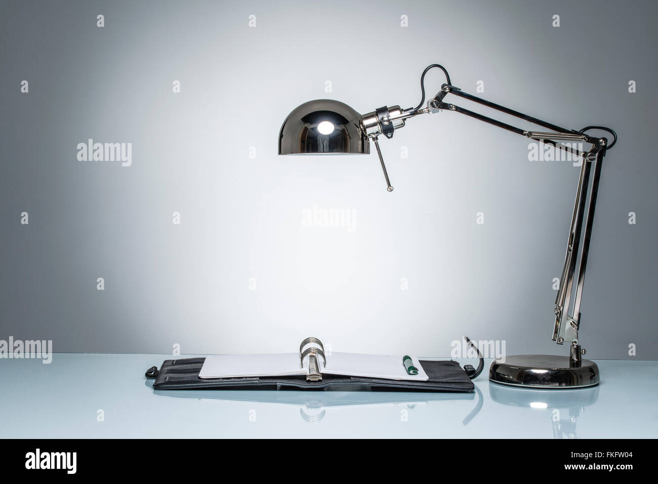 lighting up notebook diary writing with desk lamp on round studio ...