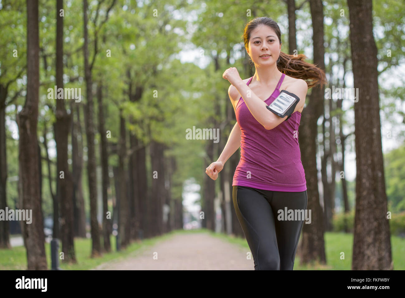 Asian young woman jogging in the forest, cell phone lifestyle Stock ...