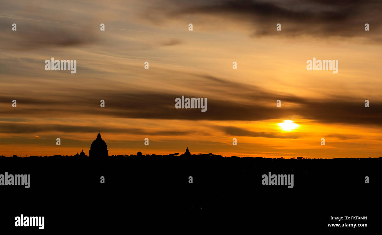 A red sunset behind the St. Peters Basilica in Rome, Italy Stock Photo ...