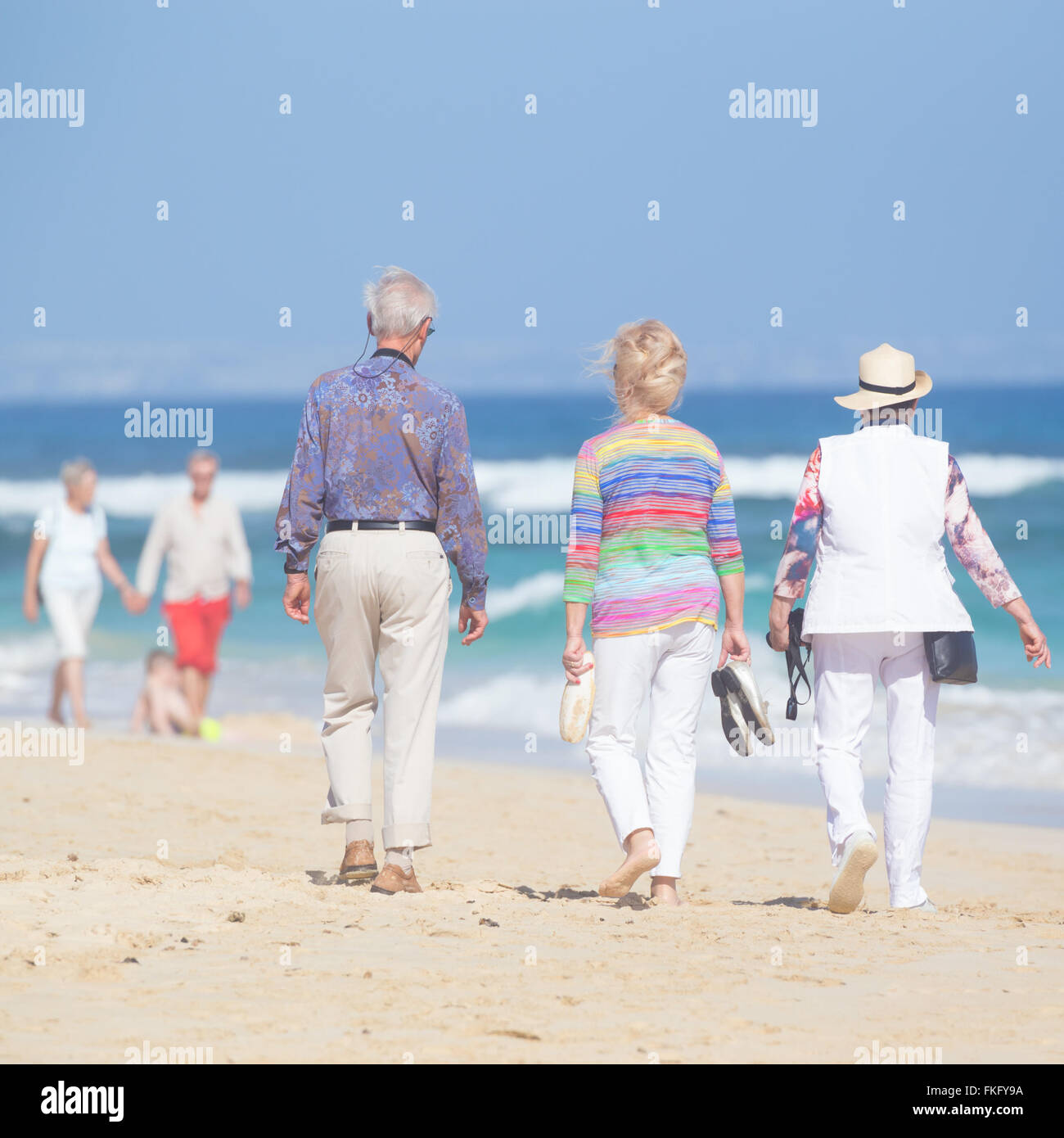 Active seniors enjoying beach walk Stock Photo - Alamy