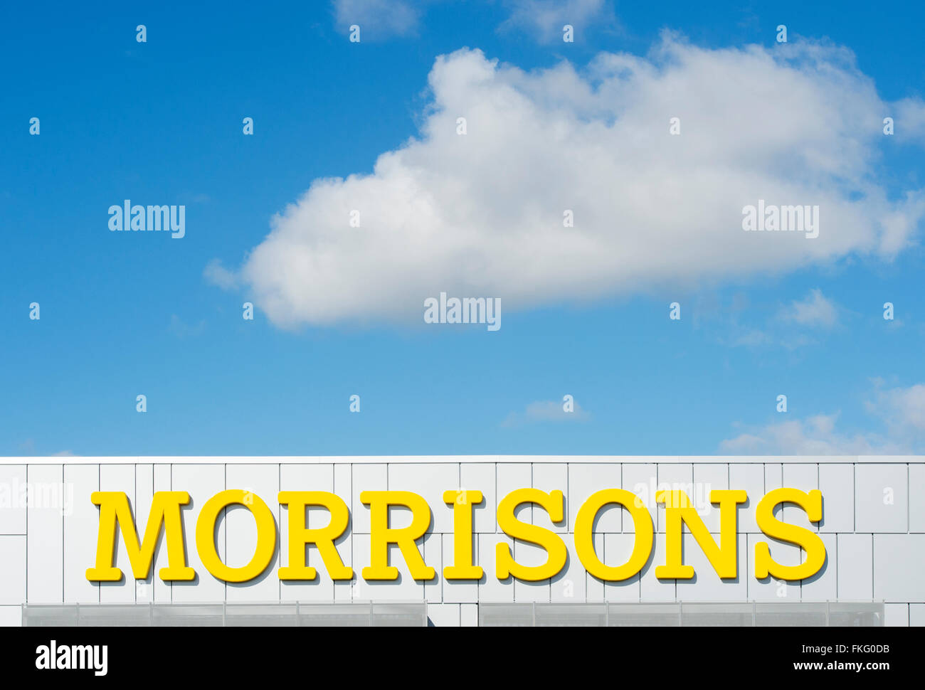 Morrisons supermarket sign against a blue cloudy sky Stock Photo - Alamy