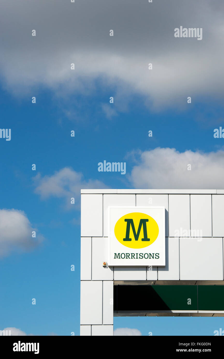 Morrisons supermarket sign against a blue cloudy sky Stock Photo - Alamy