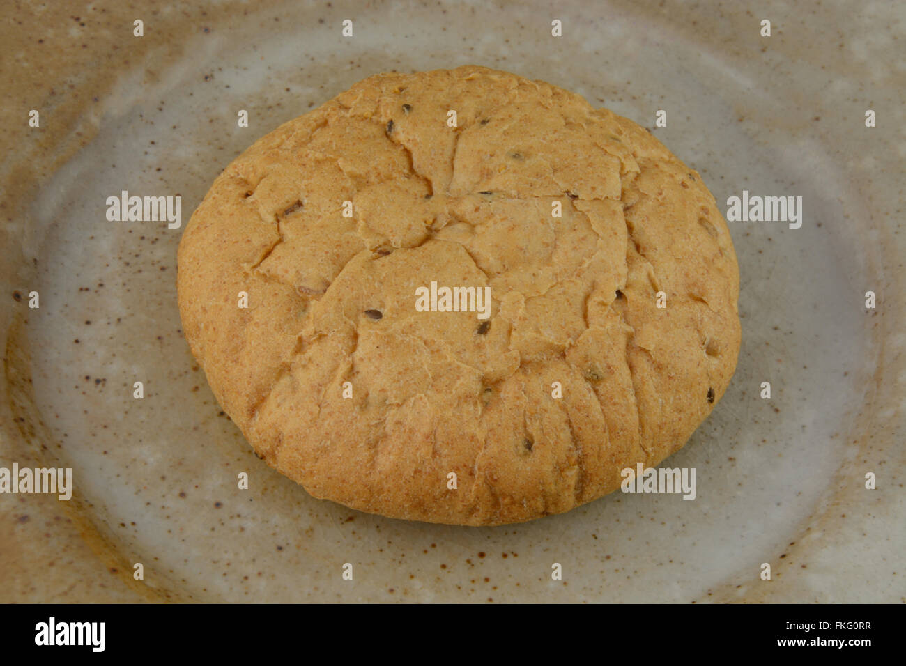 Round loaf of wholegrain bread with seeds and nuts on plate Stock Photo ...