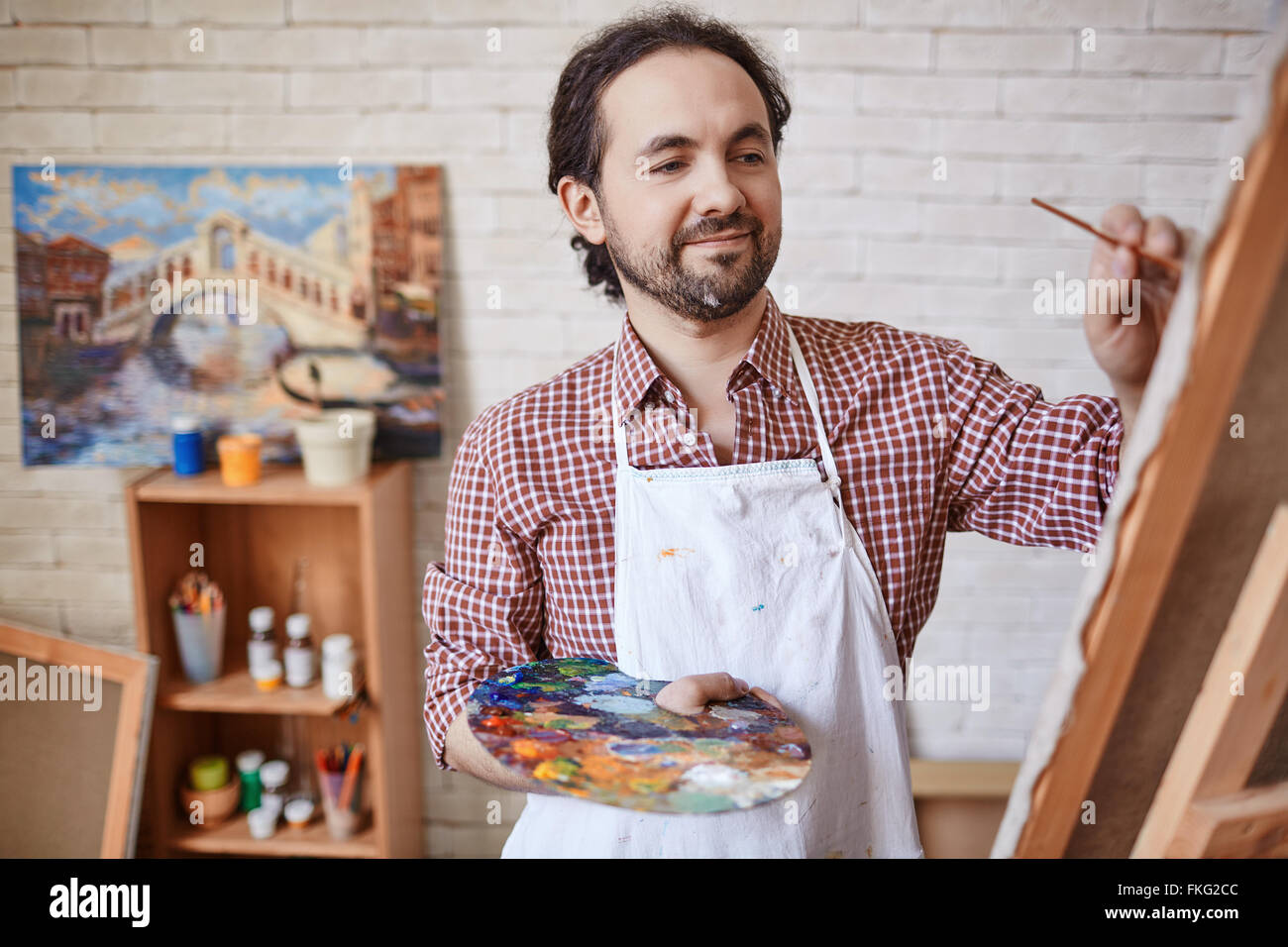 Artist painting in his art studio Stock Photo - Alamy