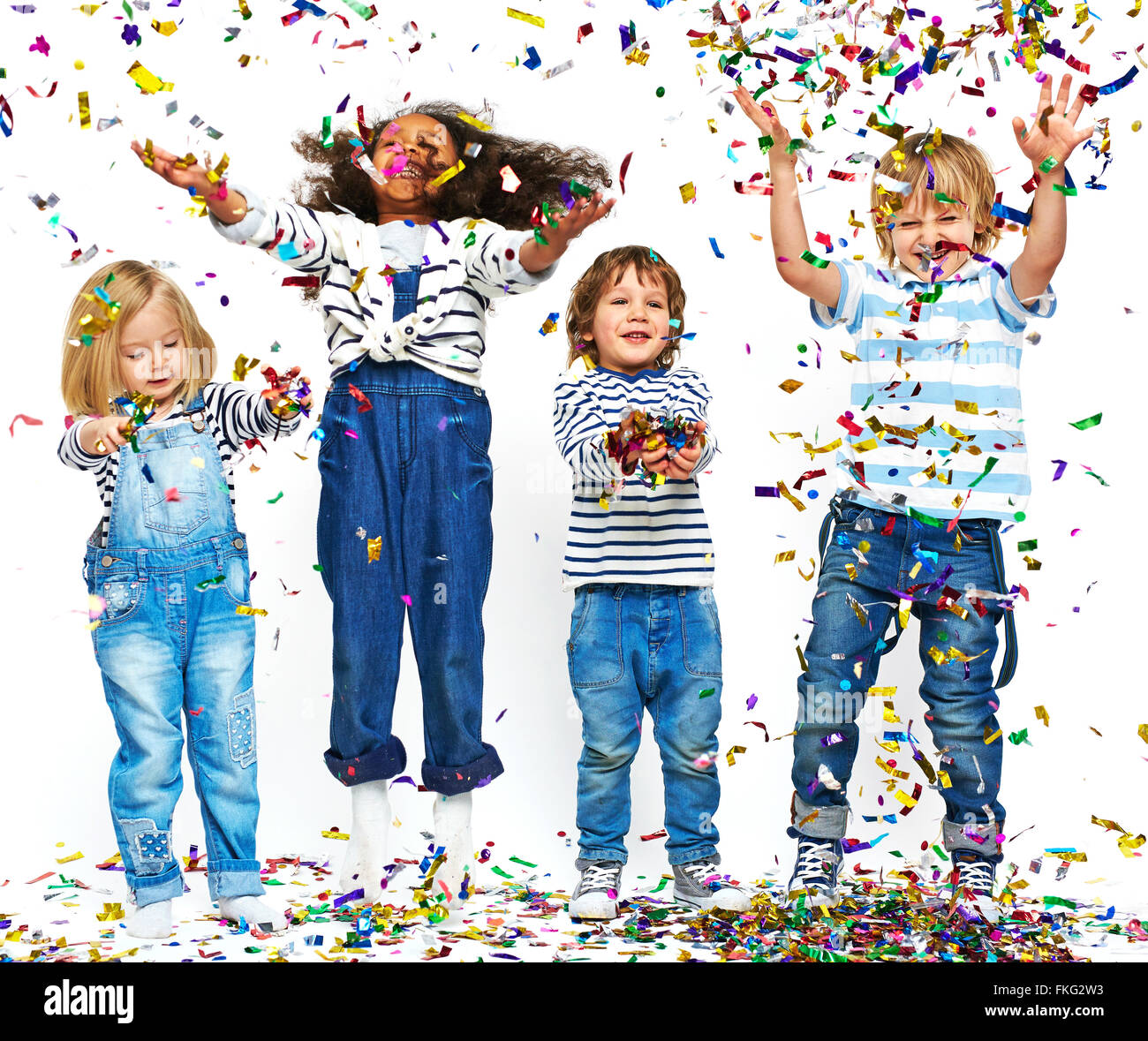 Happy children having fun with confetti Stock Photo - Alamy