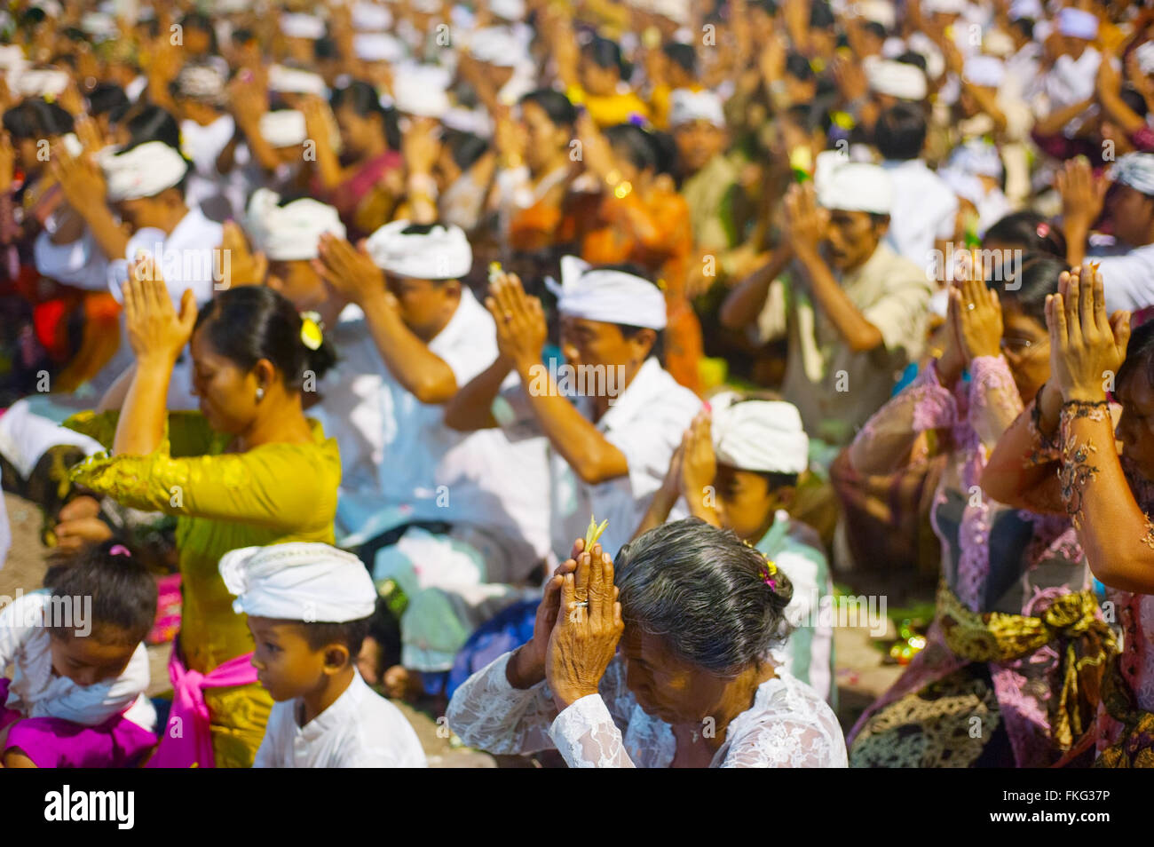 Balinese people praying during the Hindu ceremony at night. Bali New ...