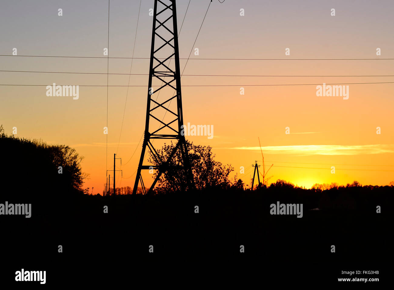 Electricity pylons, power lines and contours of trees and bushes ...
